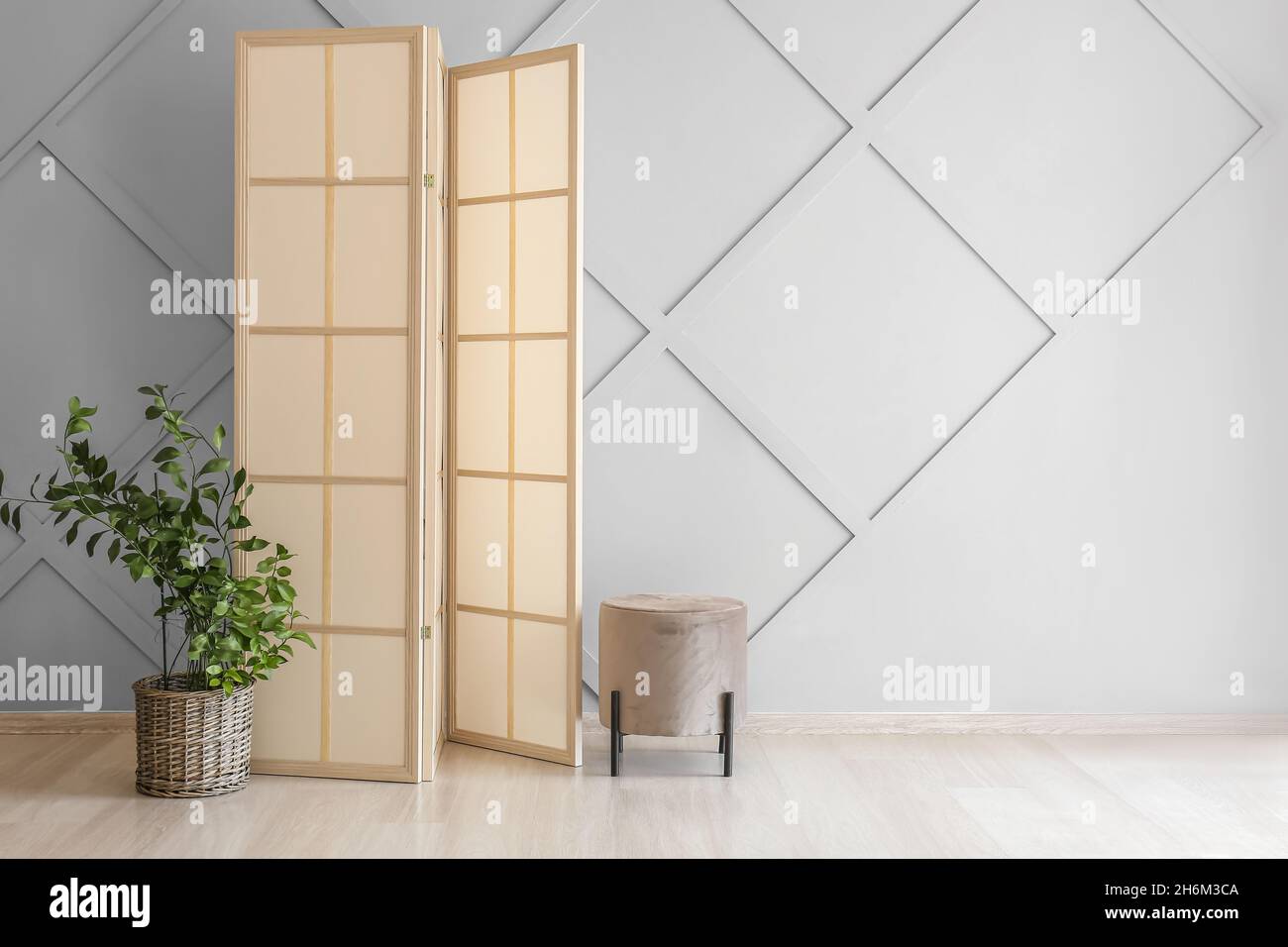 Stylish folding screen in room interior on wall background Stock Photo ...
