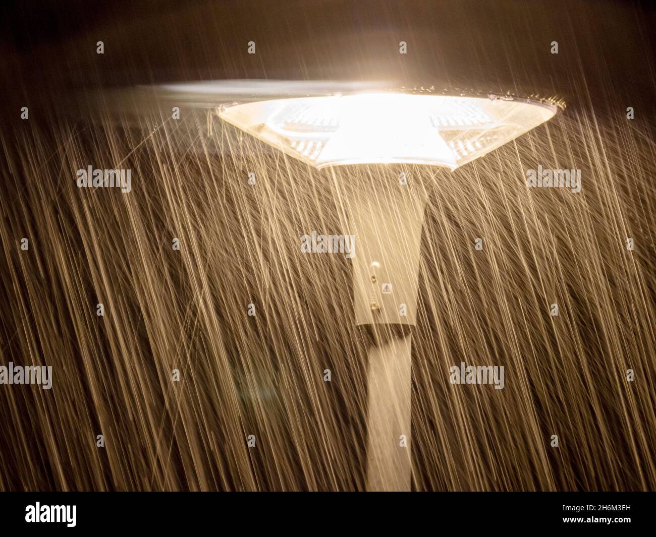 Heavy rain falling on a street lamp in Ambleside, Lake District, UK ...