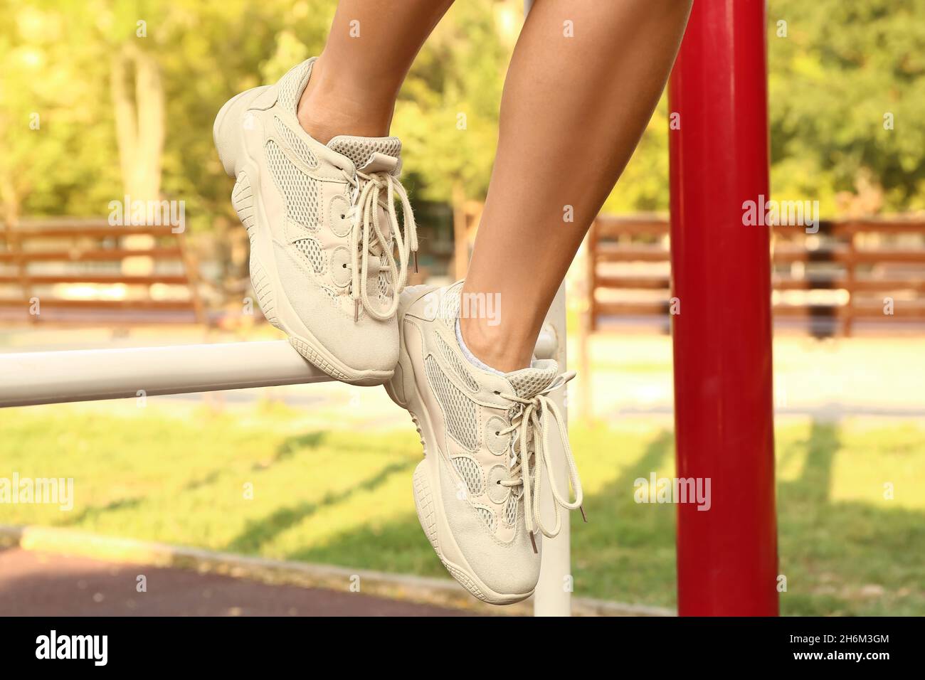 Woman in white sneakers training on sport ground, closeup Stock Photo ...