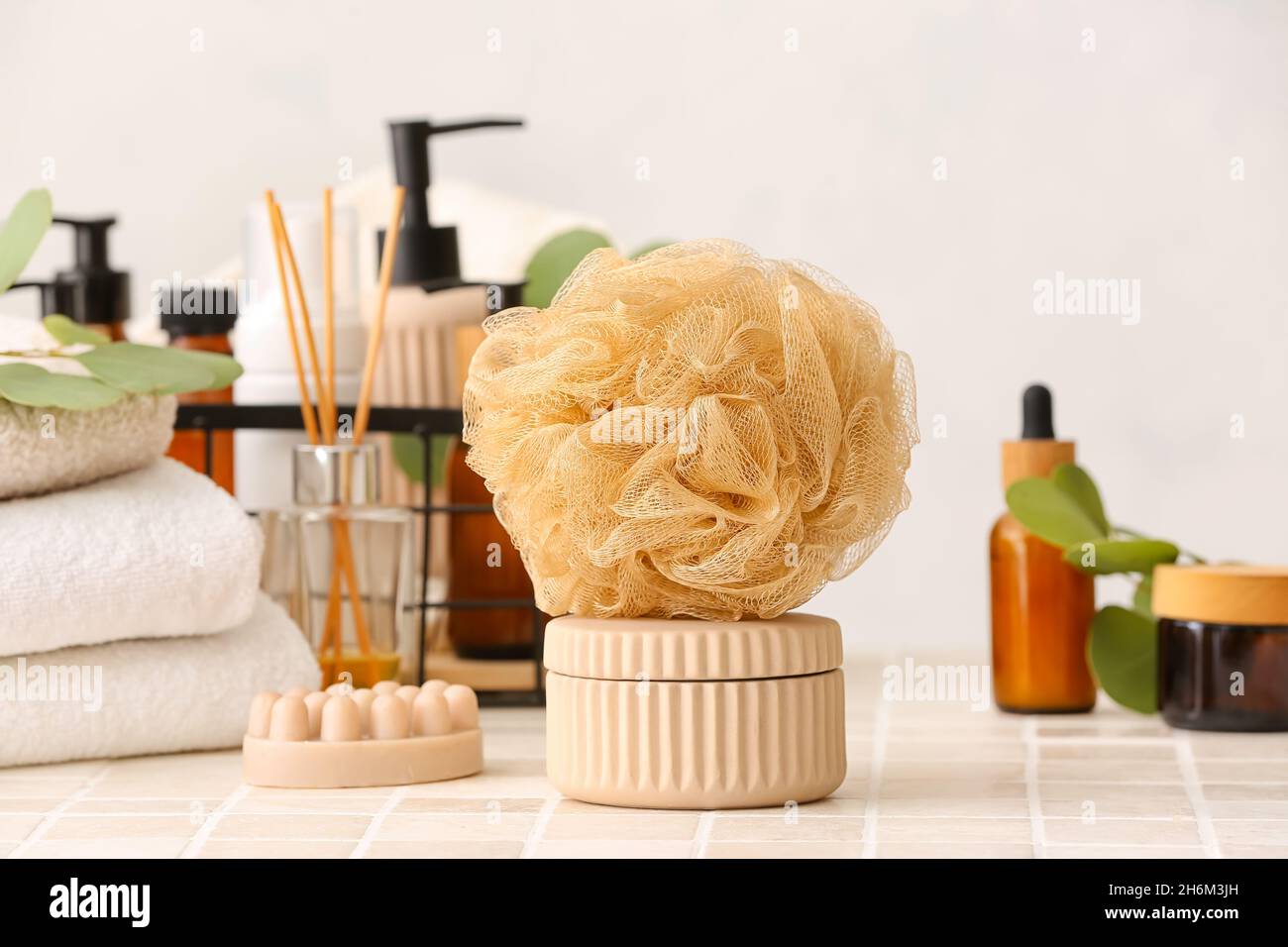 Sponge, massage soap bar and bath supplies on tile table Stock Photo ...