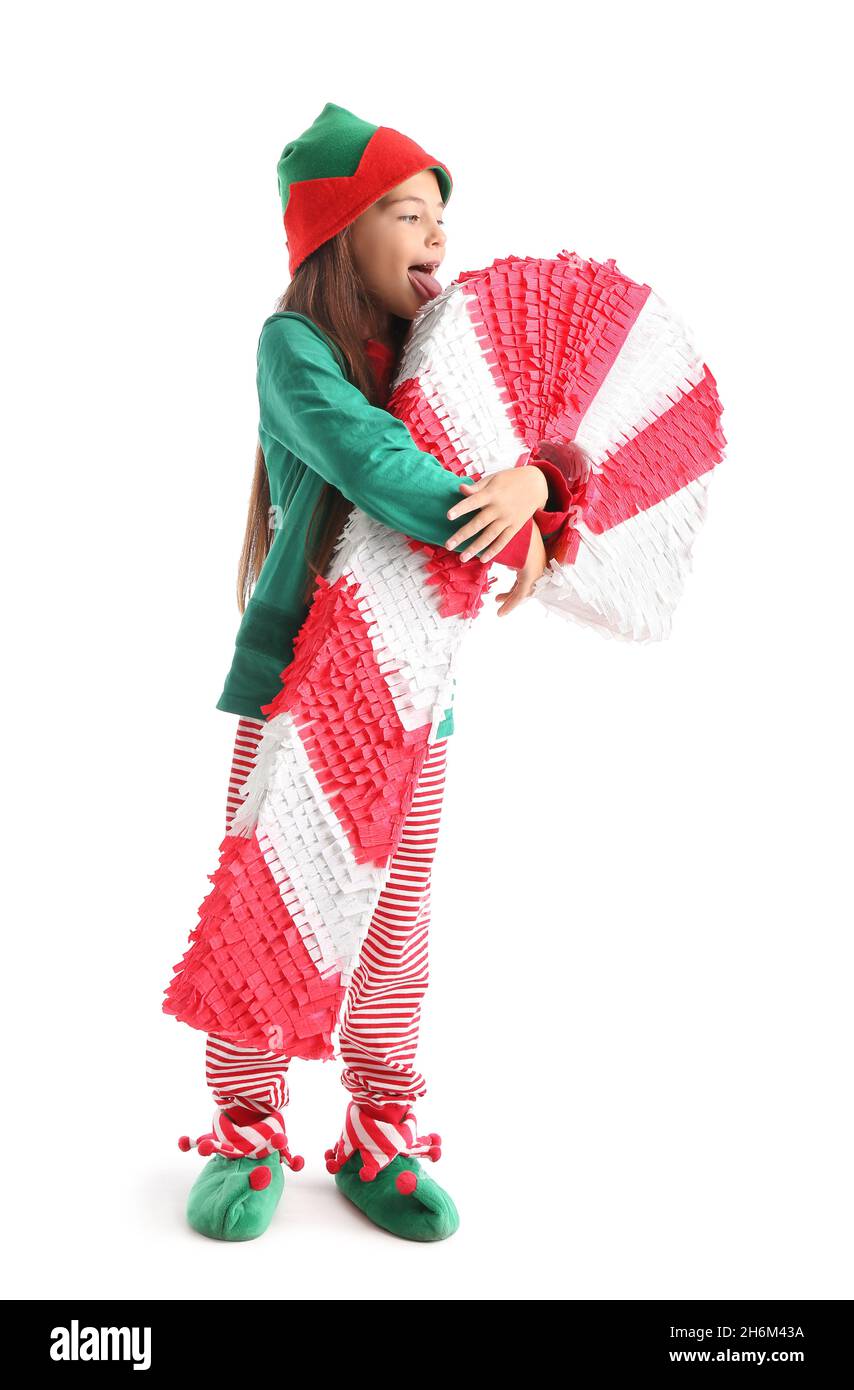 Little girl dressed as elf with candy cane pinata on white background ...