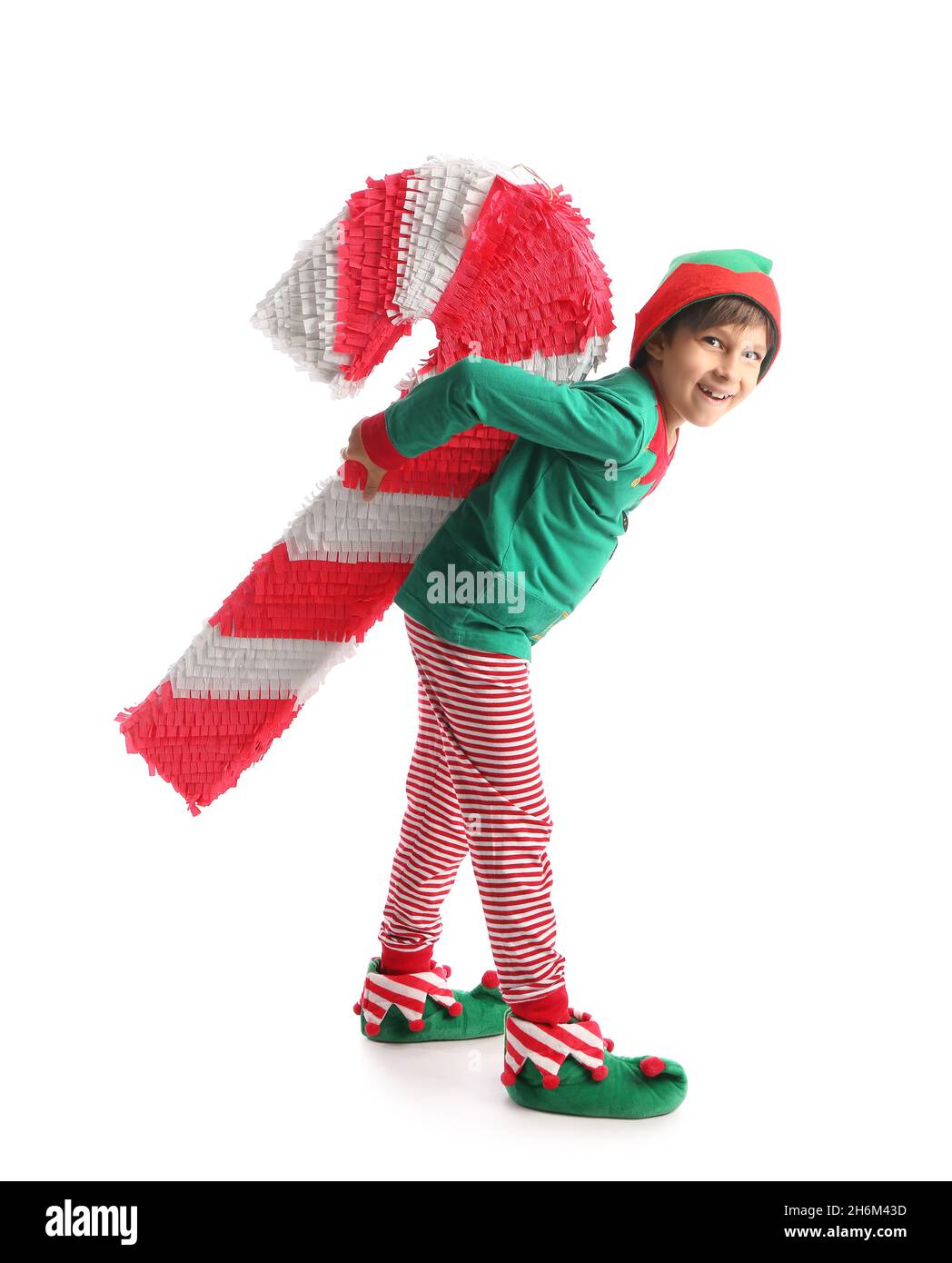Cute little boy dressed as elf with candy cane pinata on white ...