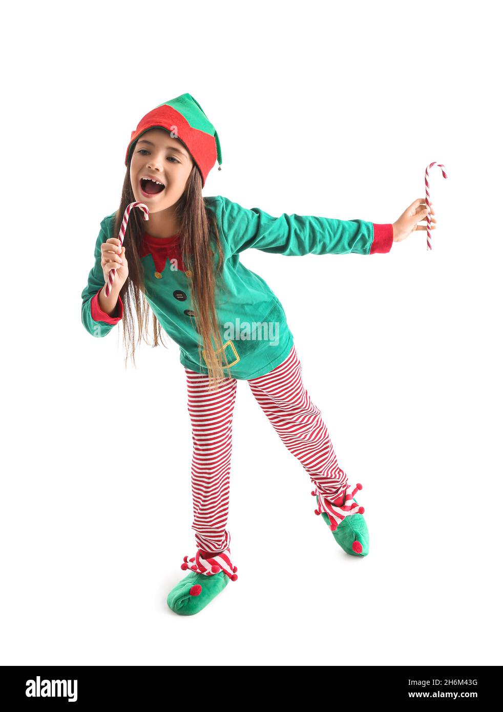 Cute little elf with candy canes on white background Stock Photo - Alamy