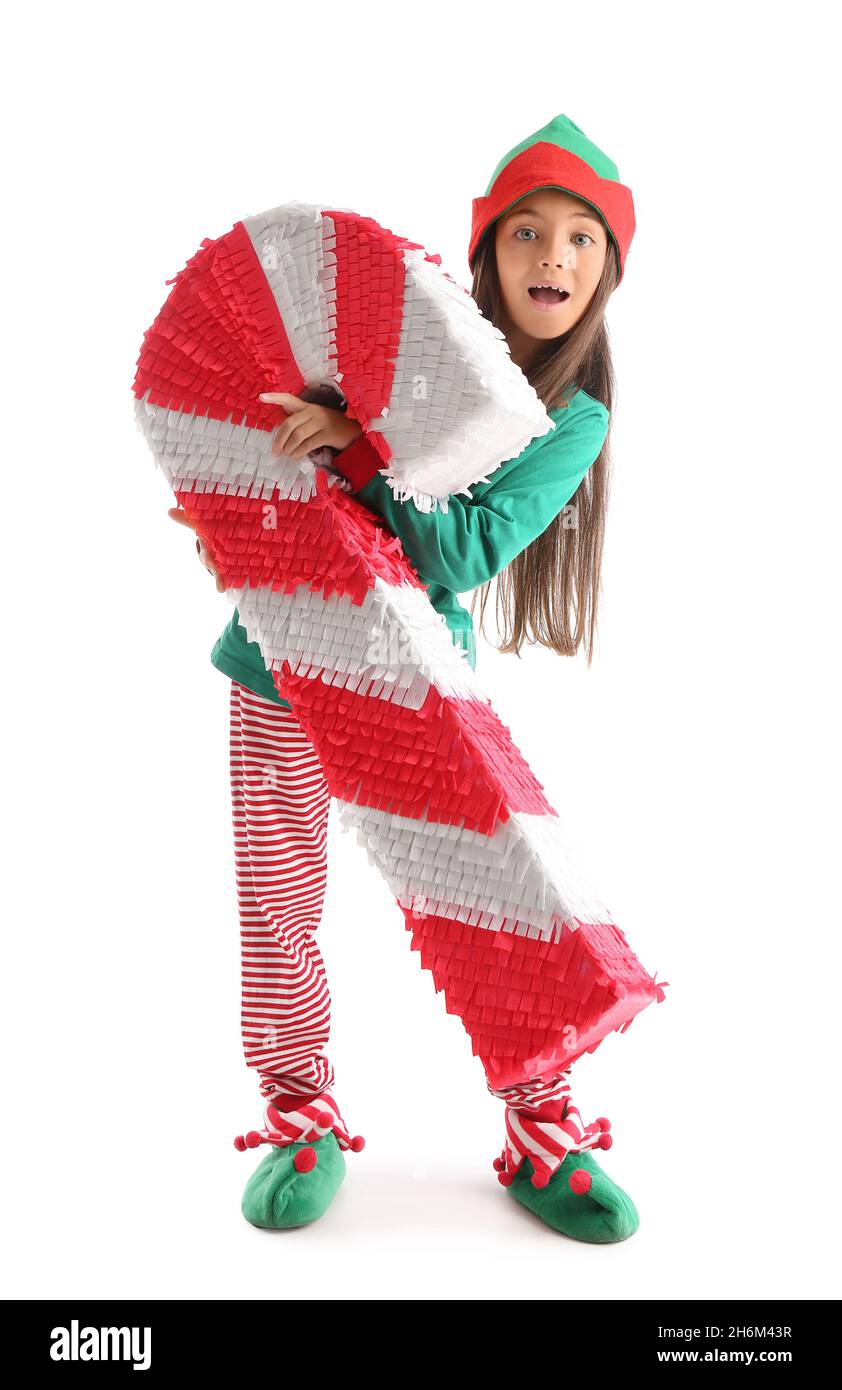 Little girl dressed as elf with candy cane pinata on white background ...
