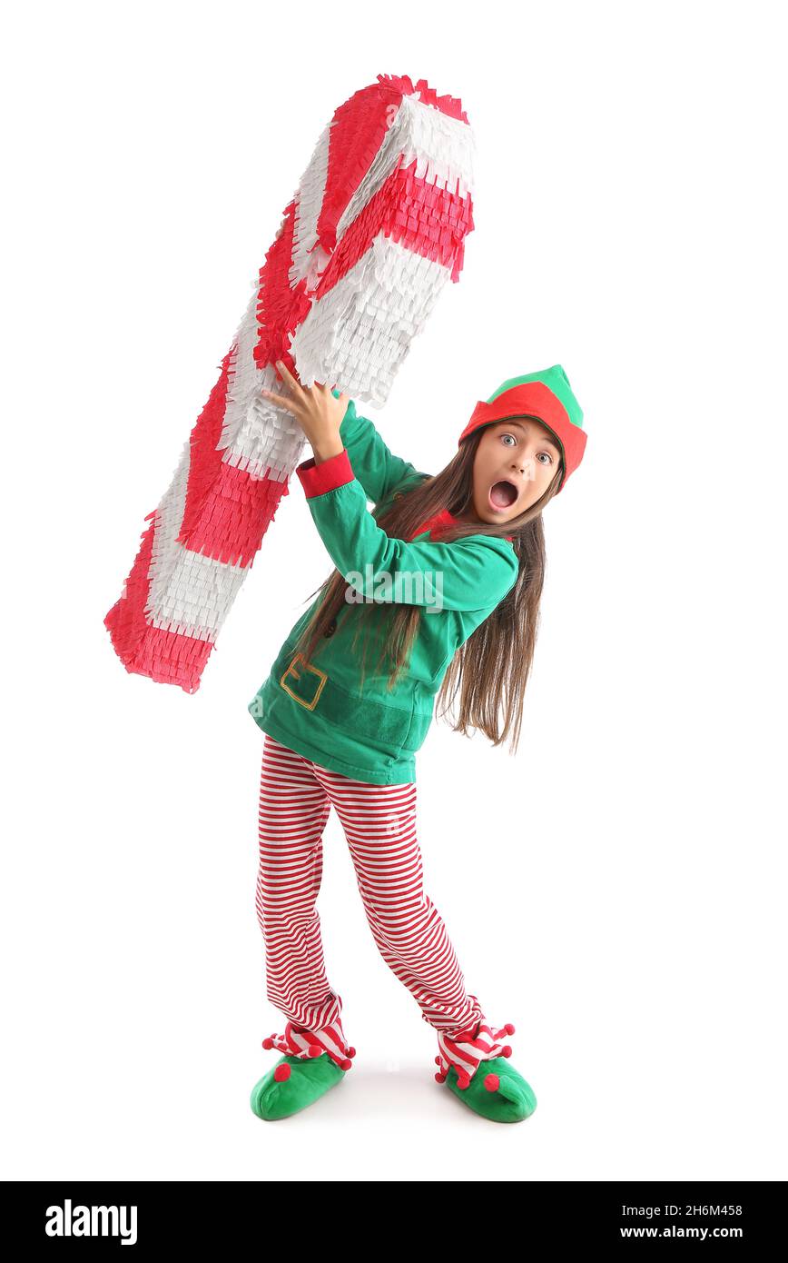 Surprised little girl dressed as elf with candy cane pinata on white ...