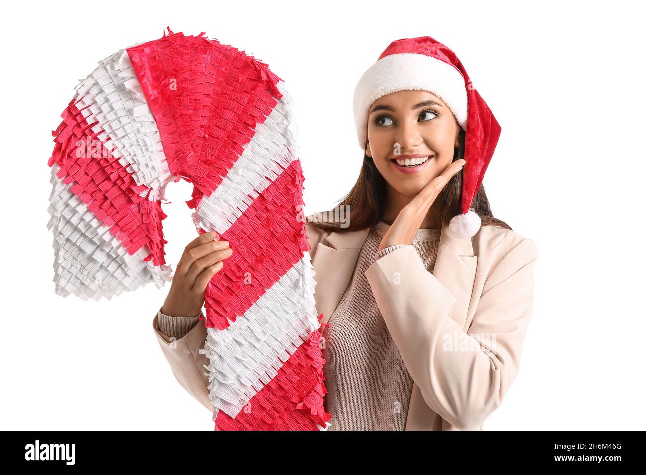 Beautiful woman in Santa hat and with candy cane pinata on white ...