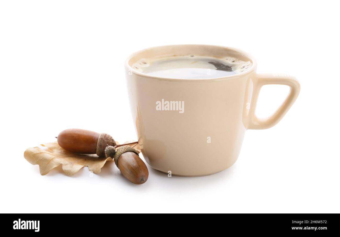 Cup of coffee with acorns on white background Stock Photo - Alamy