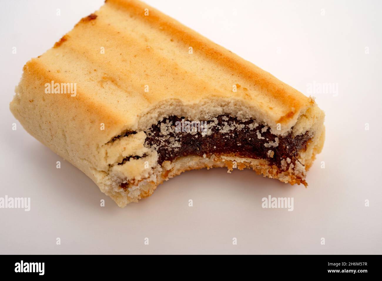 Fig roll biscuit with bite taken out Stock Photo - Alamy