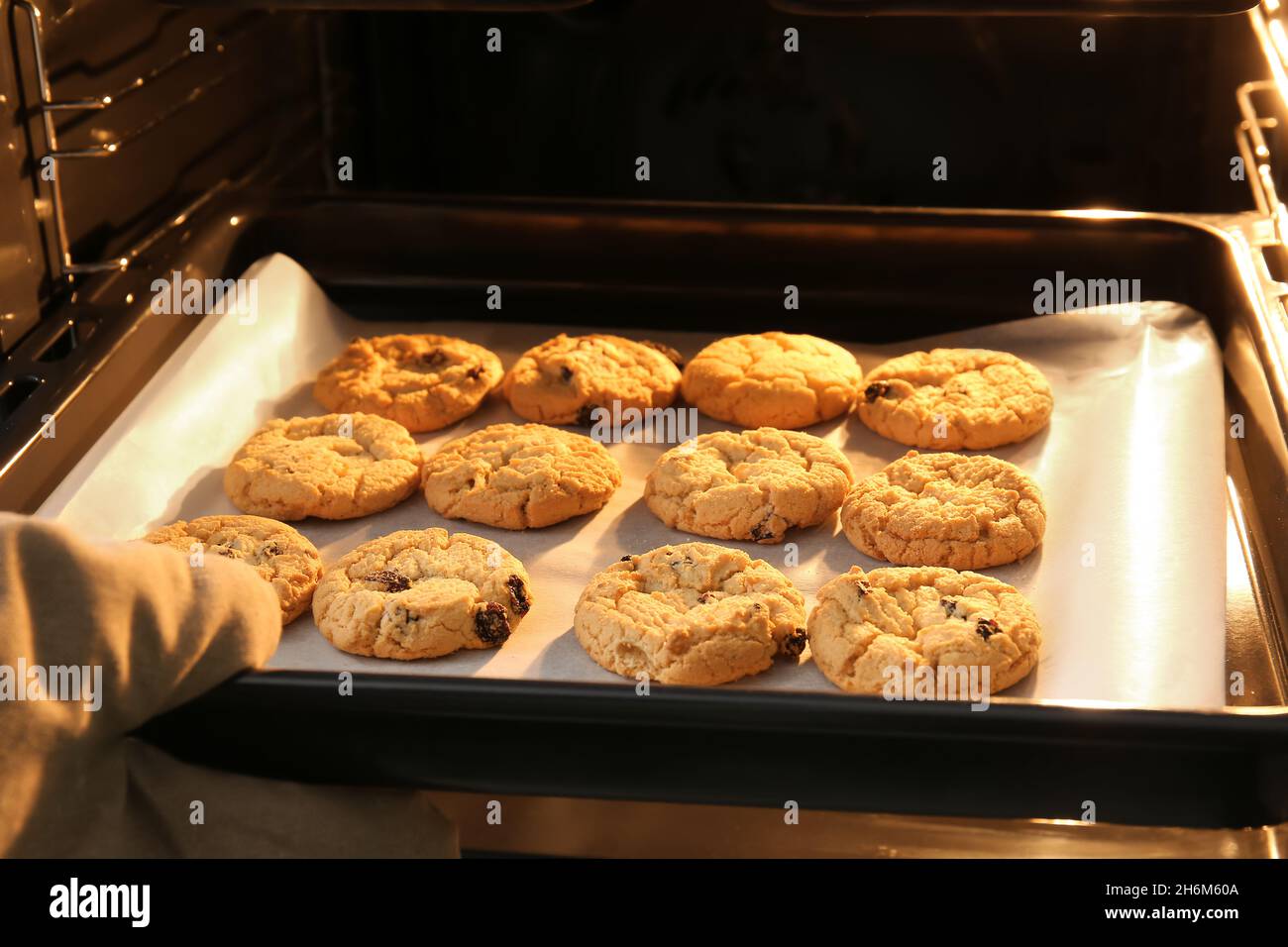 Taking cookies from oven hi-res stock photography and images - Alamy