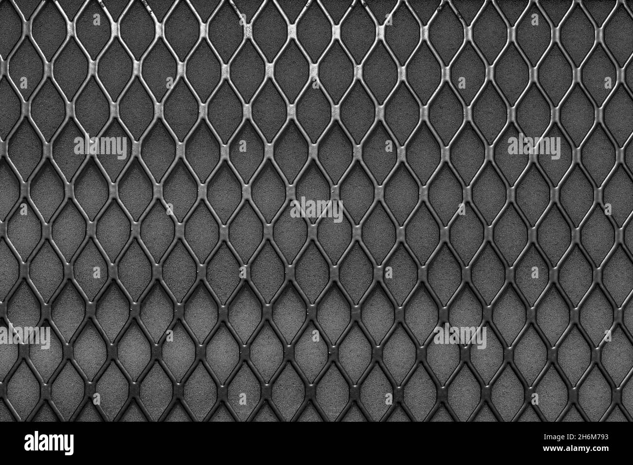 Metal grid with geometric pattern of rhombi, background. Black metallic ...