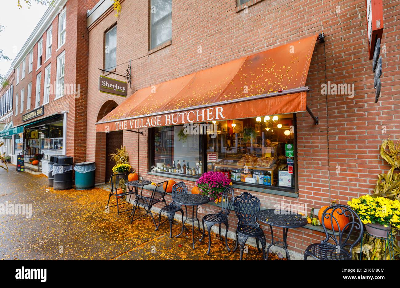 Brown awning above the shopfront of local deli 'The Village Butcher' in ...