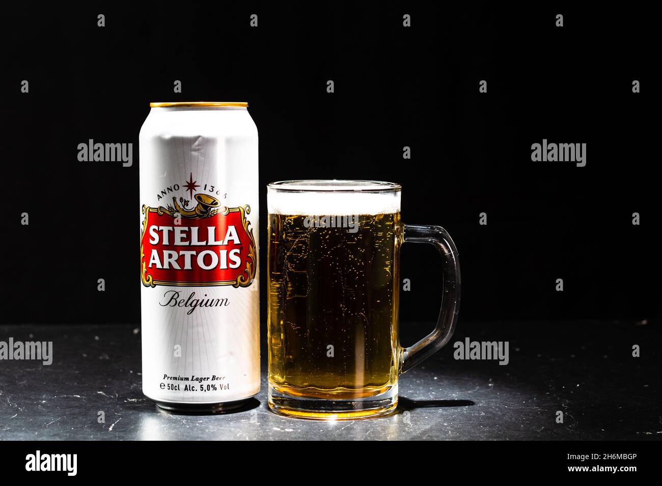 Can of Stella Artois beer and beer glass on dark background ...