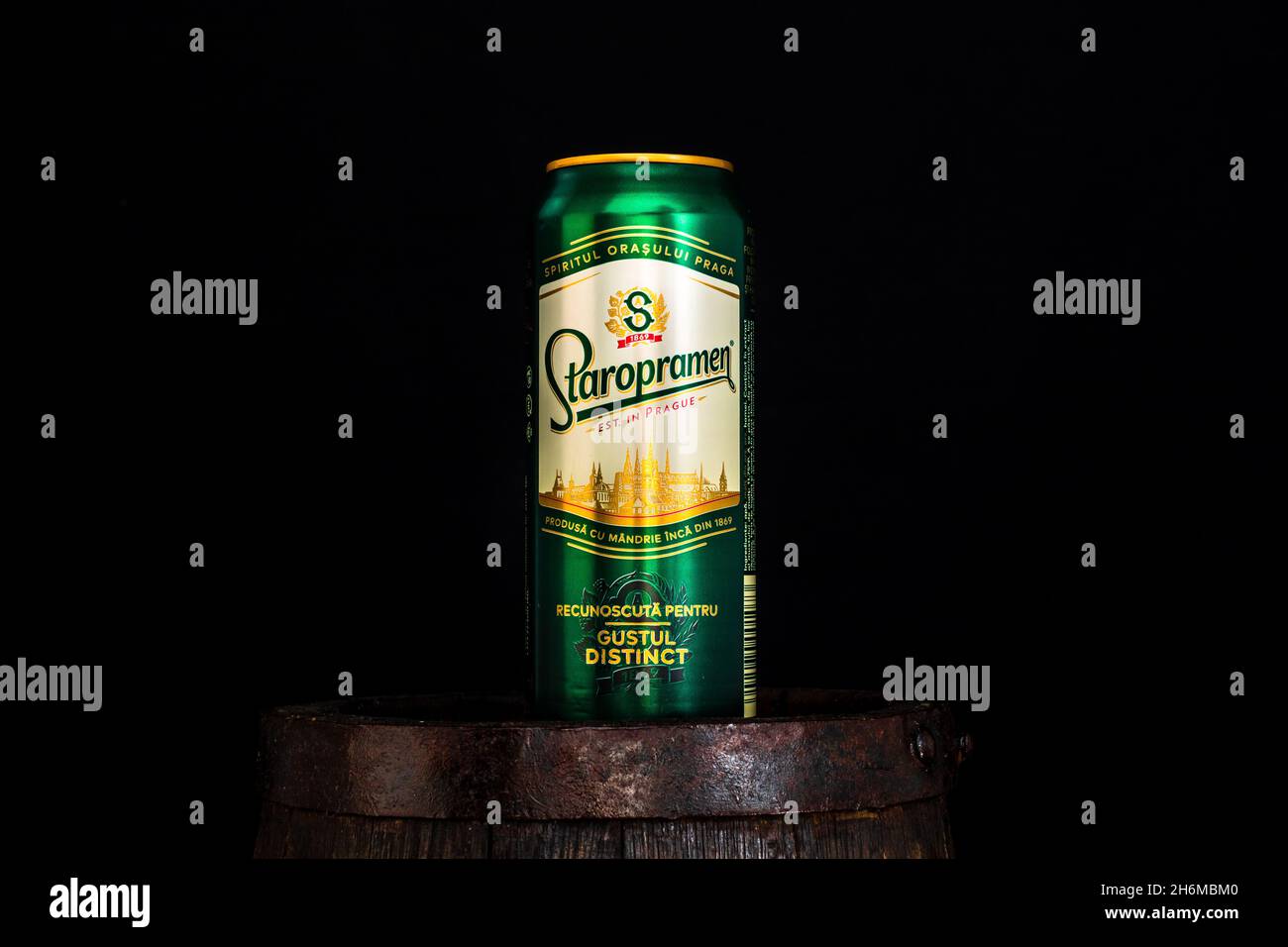 Can of Staropramen beer on beer barrel with dark background ...