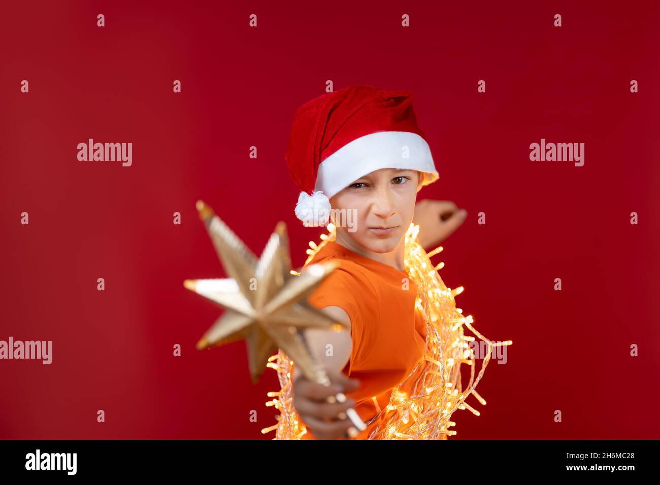 the boy has a star on the top of the Christmas tree in his hands Stock ...