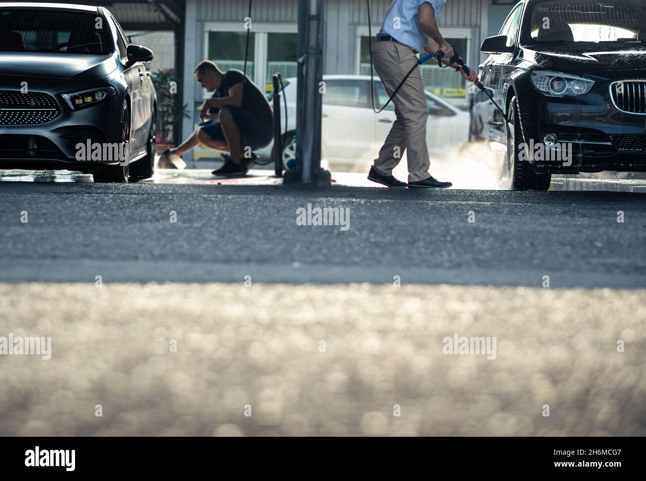 Cars being washed by their owners in a car wash Stock Photo - Alamy