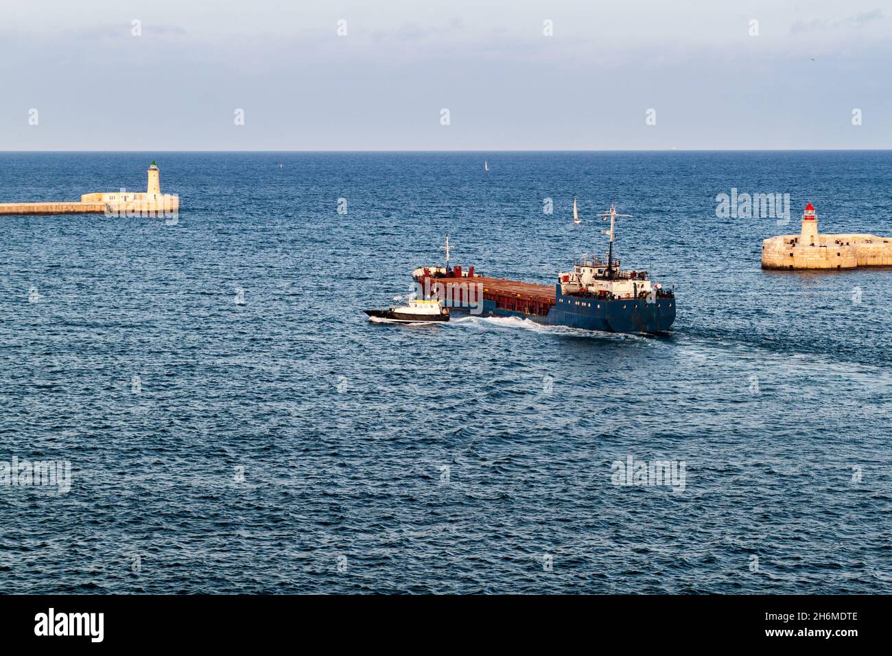 Cargo ship at the entrance to Grand Harbour in Malta Stock Photo - Alamy