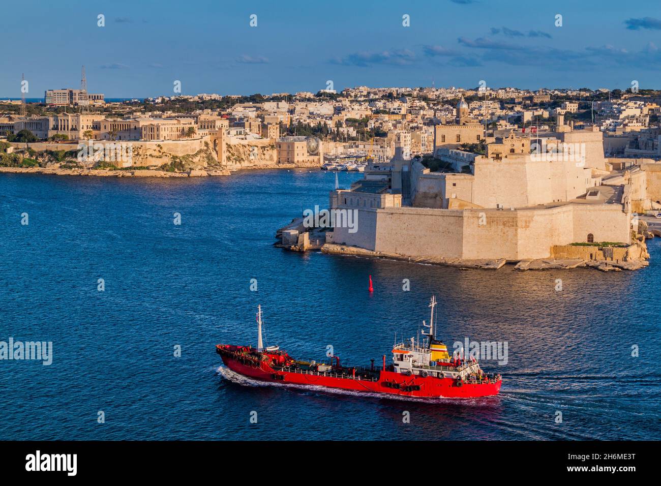 Cargo boat in front of Fort St. Angelo in Birgu town, Malta Stock Photo ...