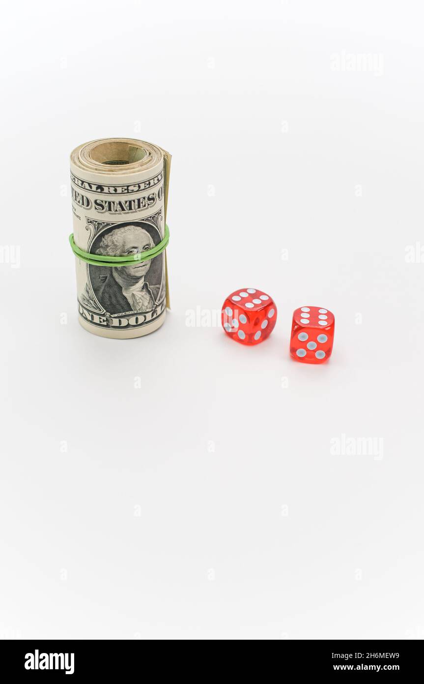 red dice and isolated US dollar banknotes roll on a white background ...