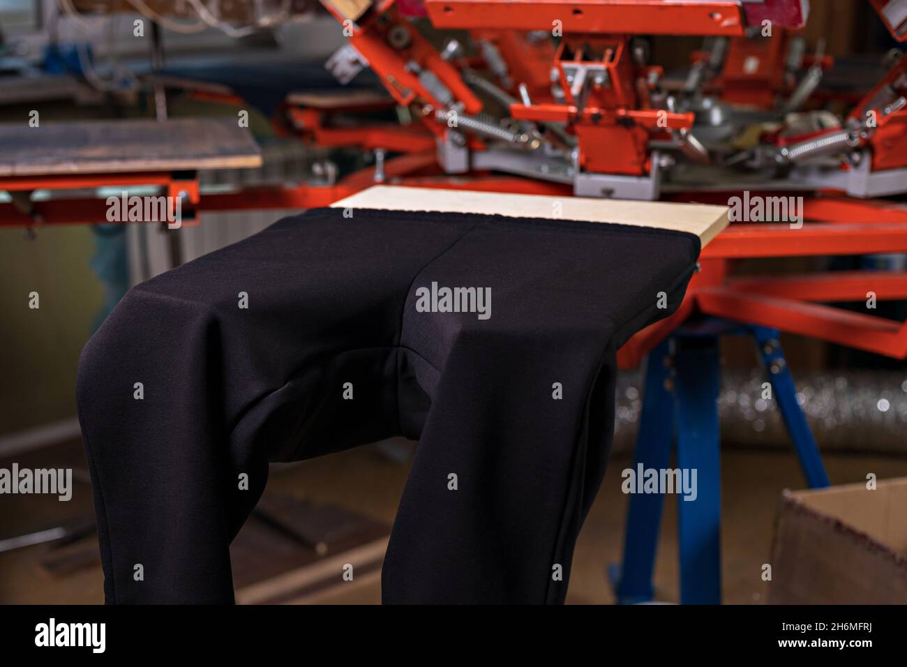 printing on pants by silk screen. serigraphy production. printing ...