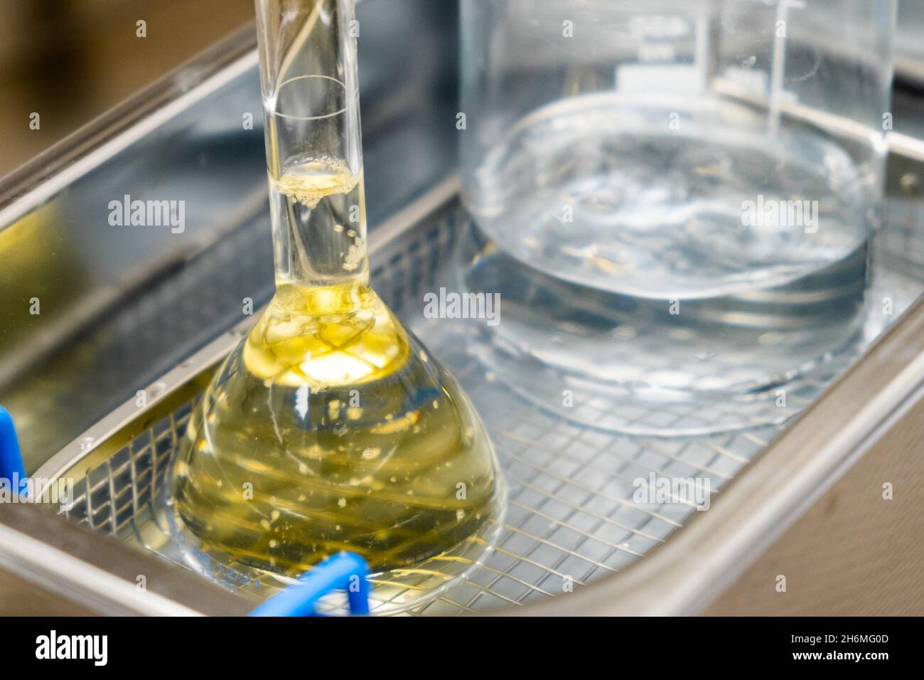 Yellow solution in the flask and beaker for dissolving or extraction ...