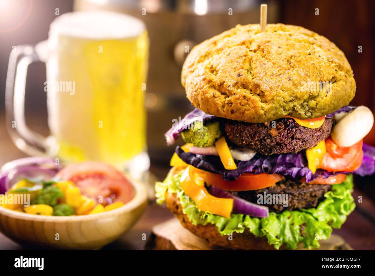 vegan burger on wholemeal bread with cold beer in the background ...