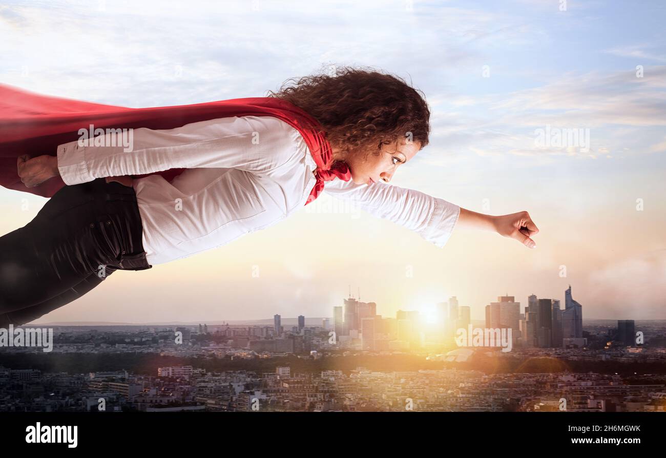 Woman acts like a superhero flying over the city Stock Photo - Alamy