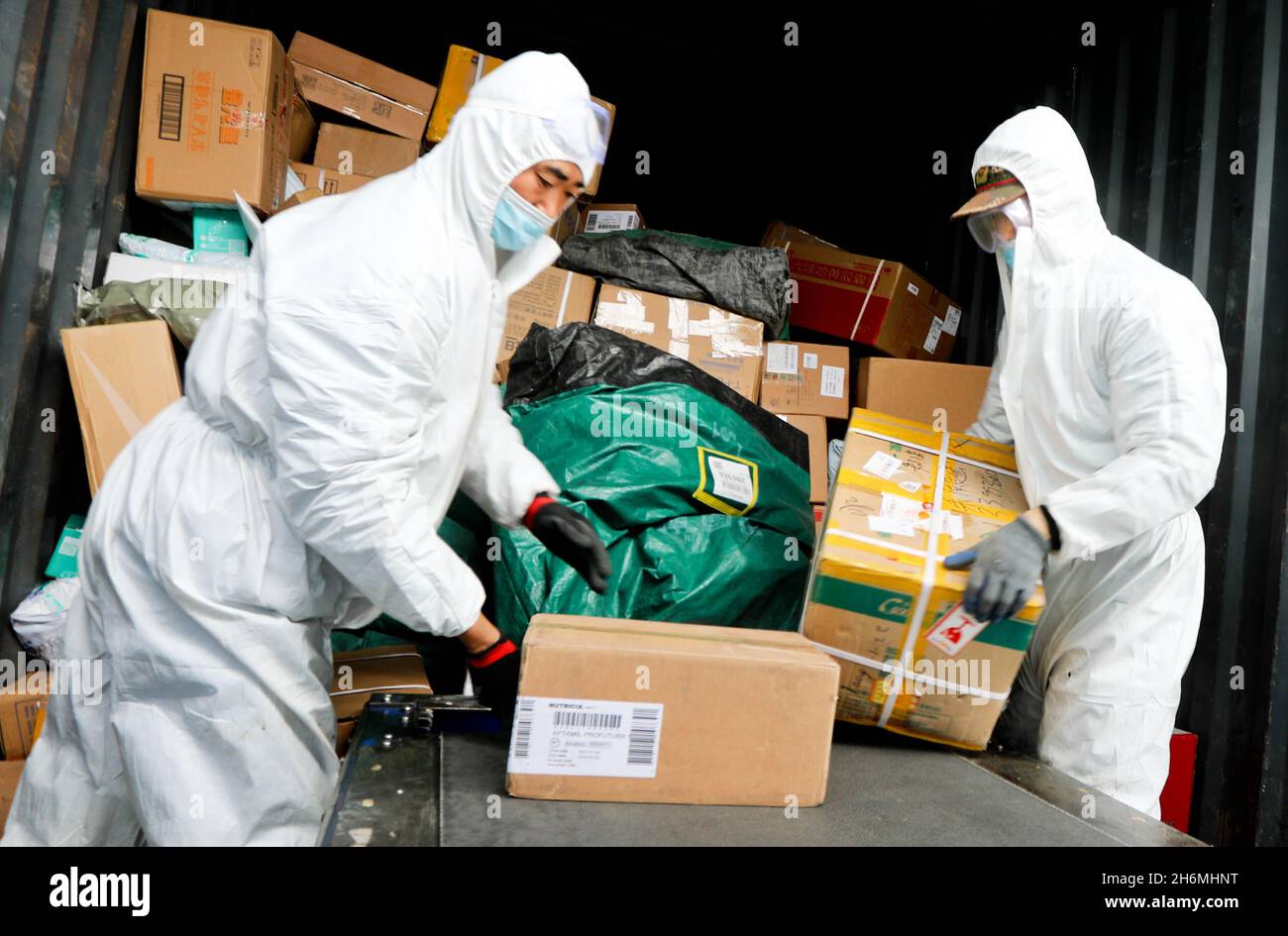 ZHANGYE, CHINA - NOVEMBER 16, 2021 - Workers unload express packages ...