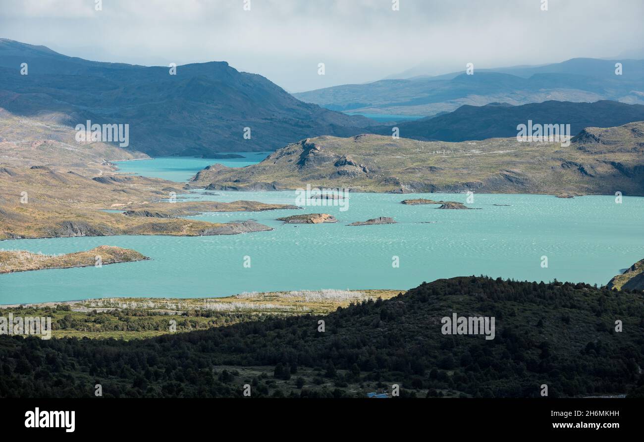 Plain hills and turquoise lake water of Torres del Paine National Park ...