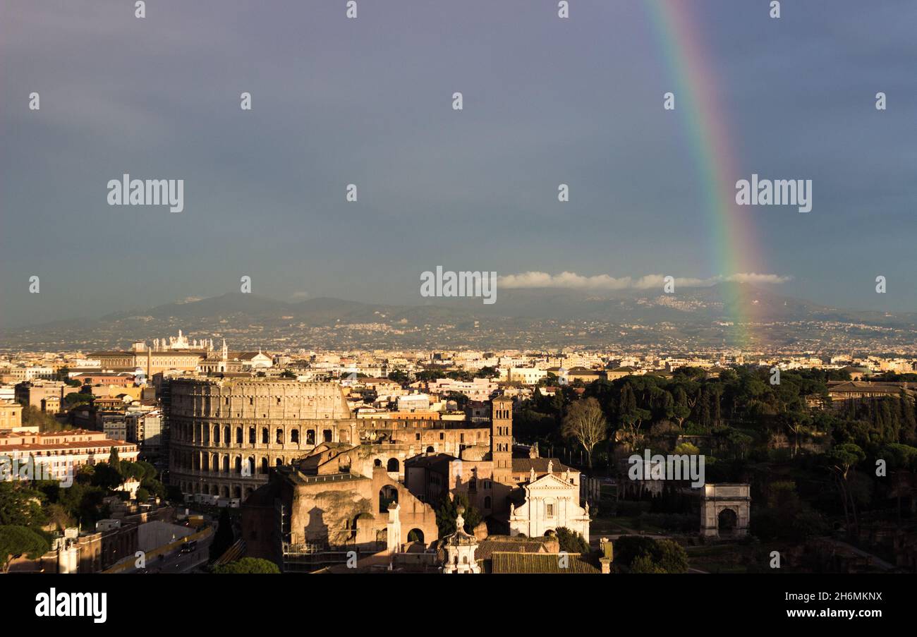 Beautiful scene of a Colosseum with a rainbow in the background in Rome ...
