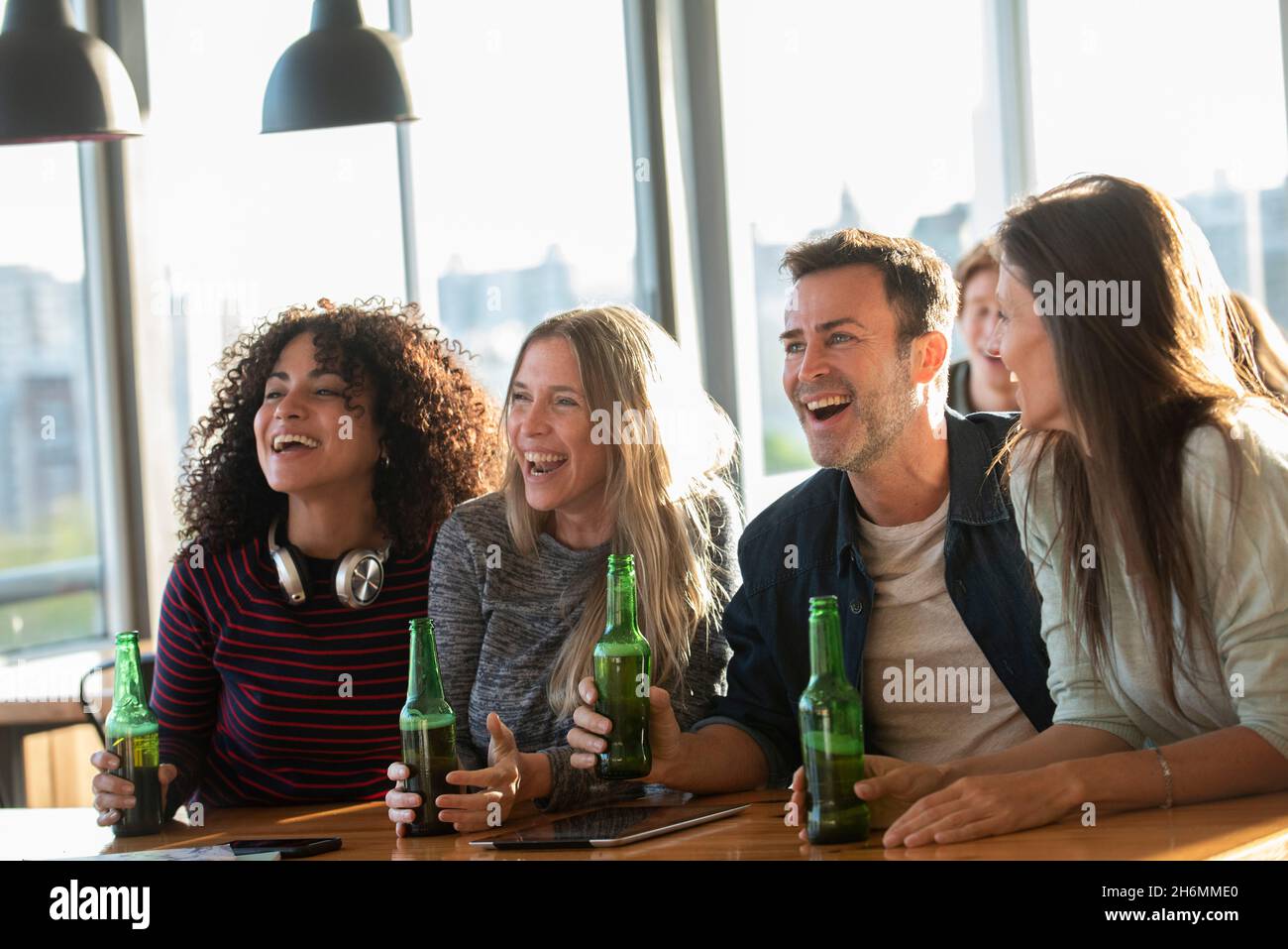 Excited business people sitting in office Stock Photo - Alamy