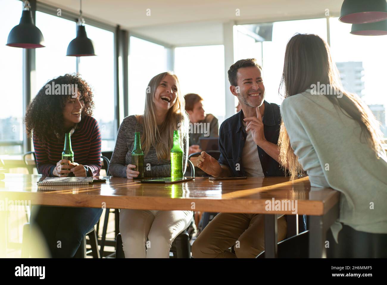 Office colleagues chatting in office Stock Photo - Alamy