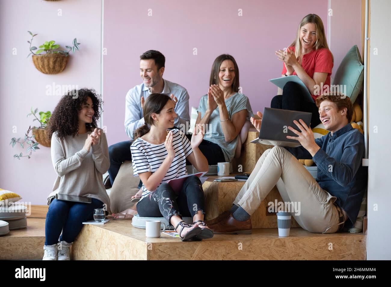 Business people clapping hands and celebrating in office Stock Photo ...