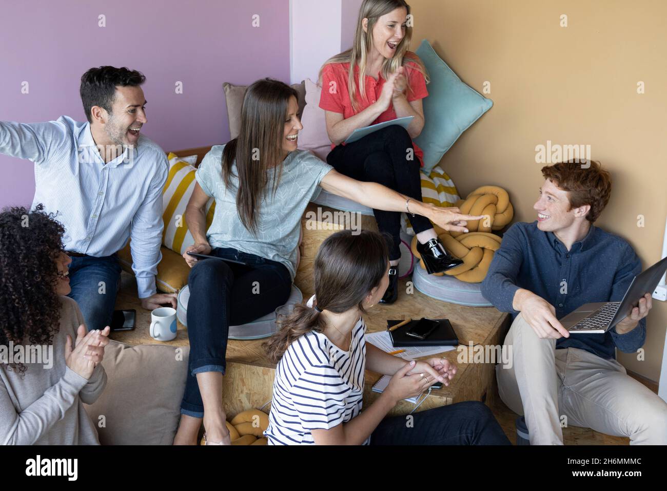 Business people clapping hands and celebrating in office Stock Photo ...
