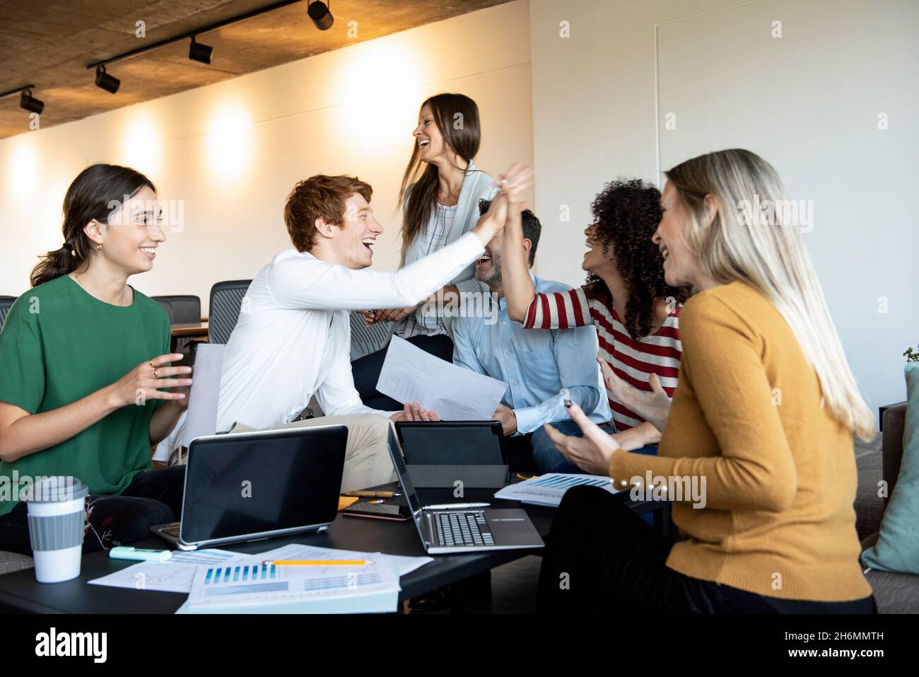Male group high five hi-res stock photography and images - Alamy