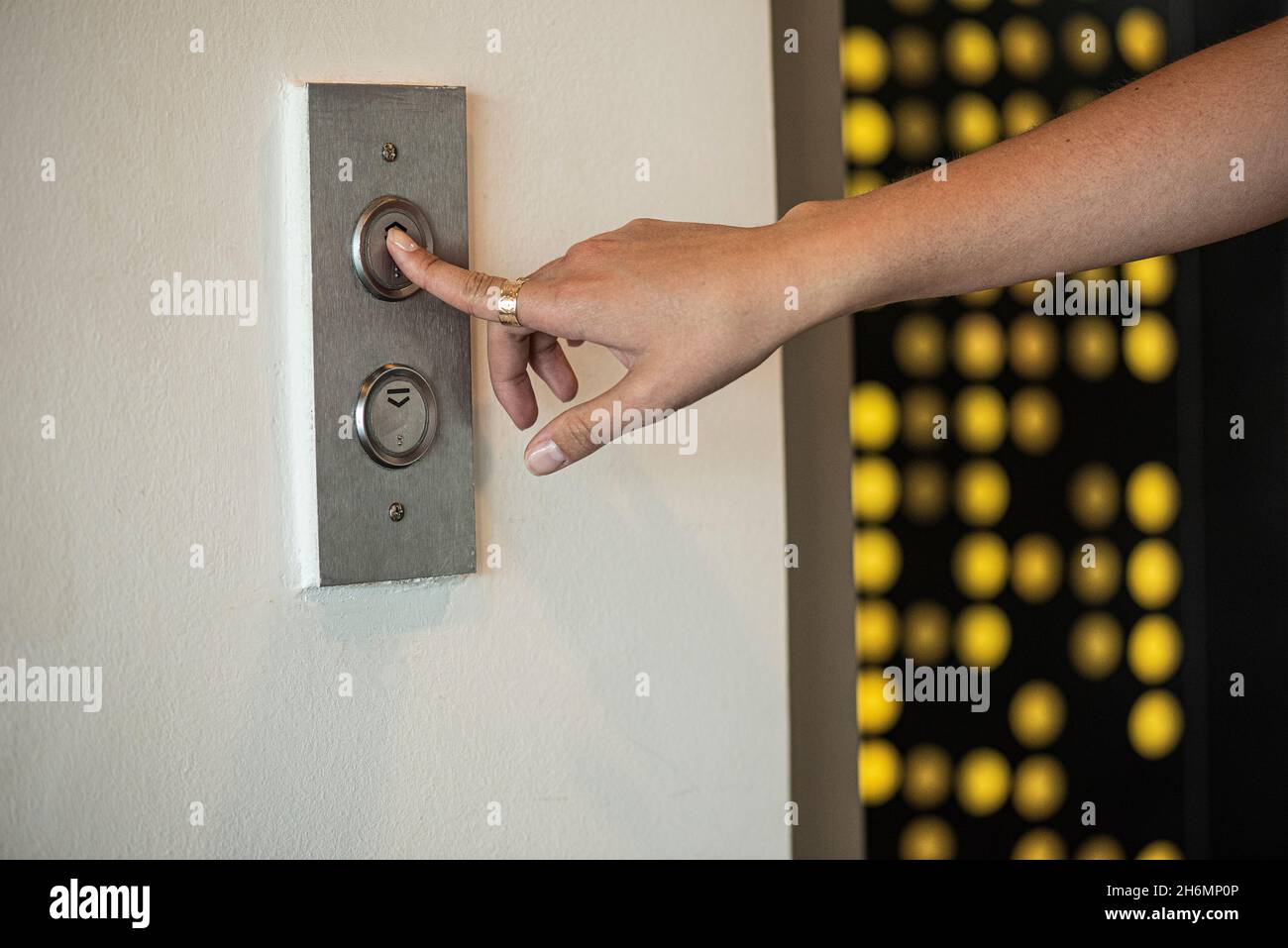 Close-up of woman's finger pressing push button Stock Photo - Alamy