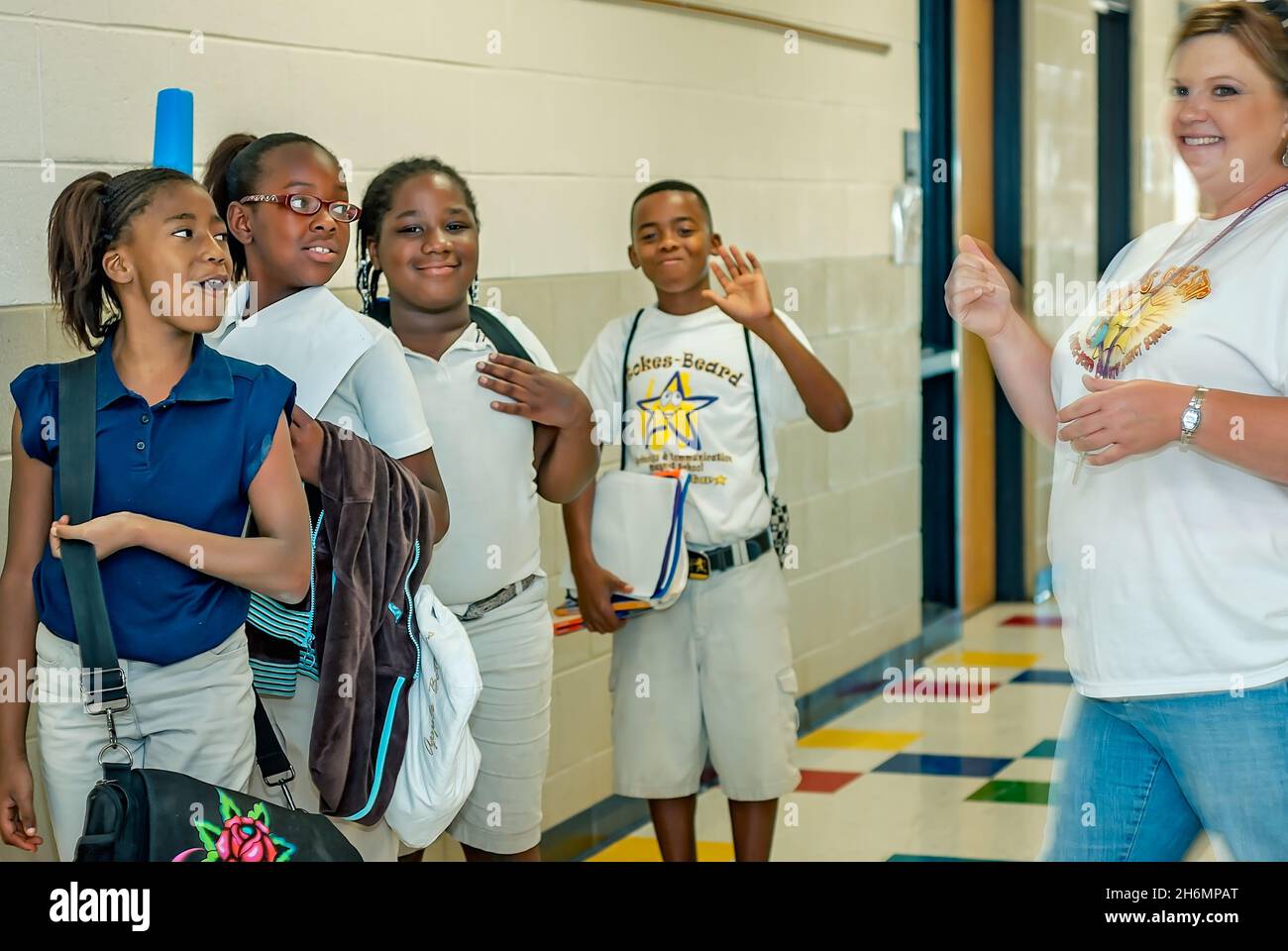 Elementary school students wave goodbye to their teachers as they line ...