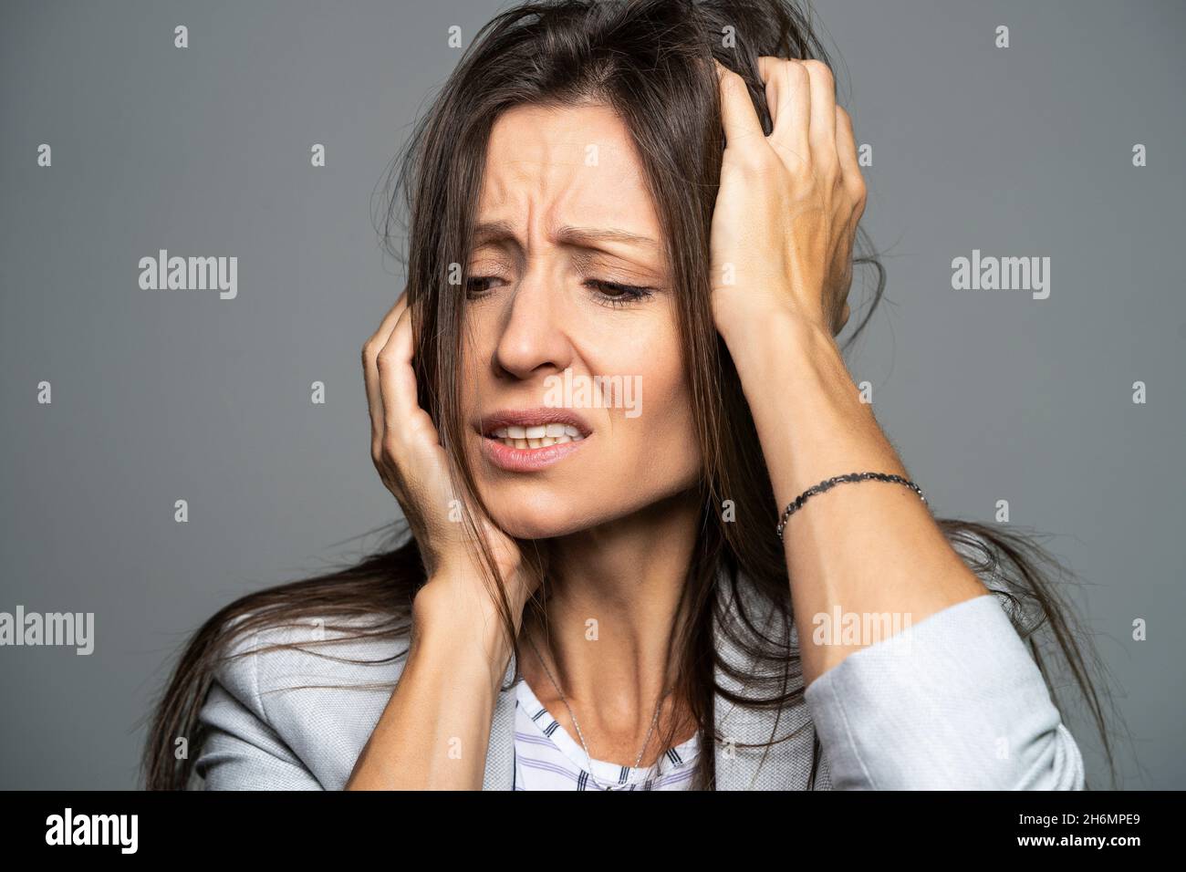 Close-up of mature woman with hand in hair Stock Photo - Alamy