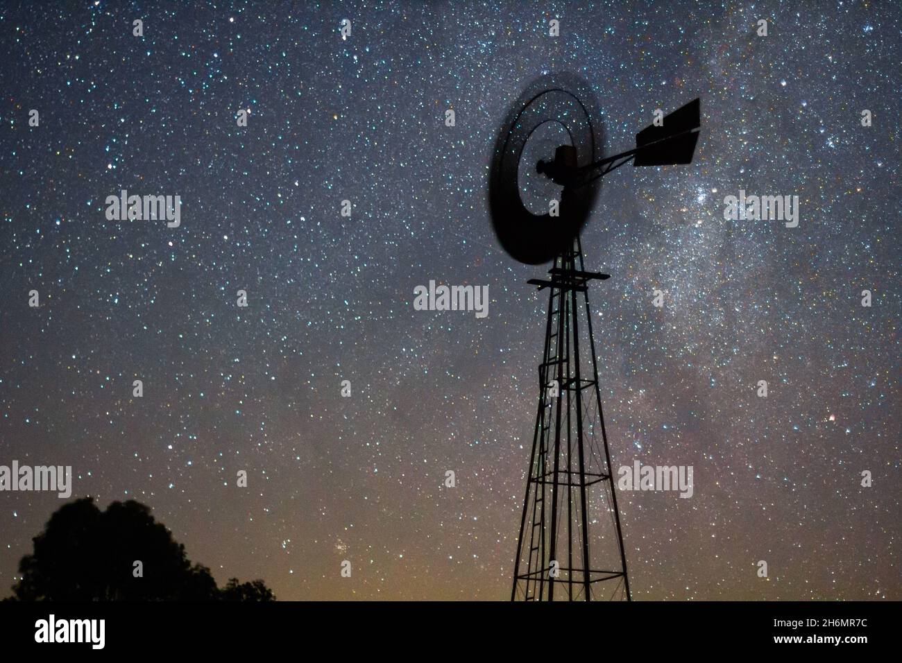 View of aermotor windmill spinning against milky way in sky Stock Photo ...