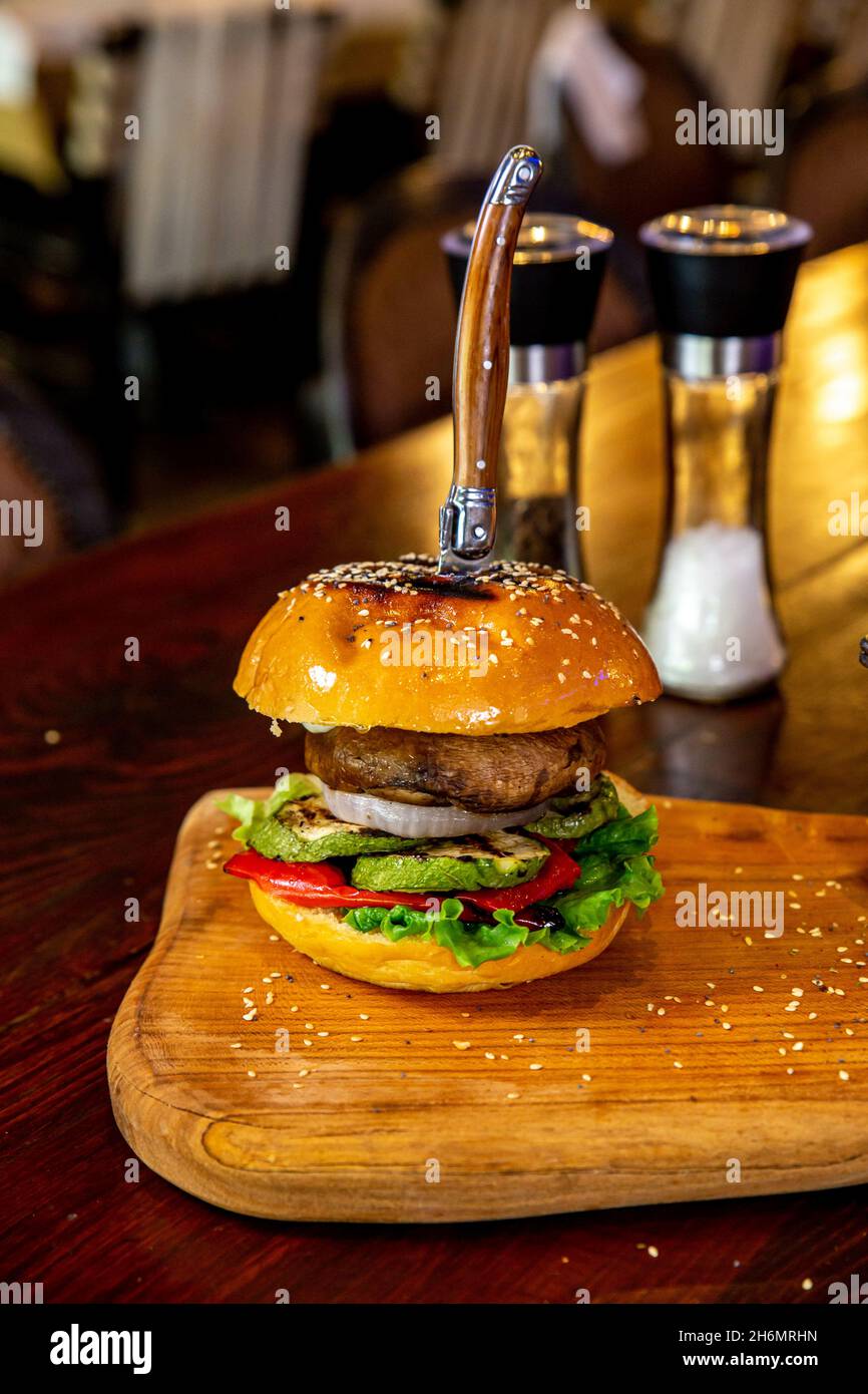 Vertical shot of a delicious burger serving at a cafe Stock Photo - Alamy