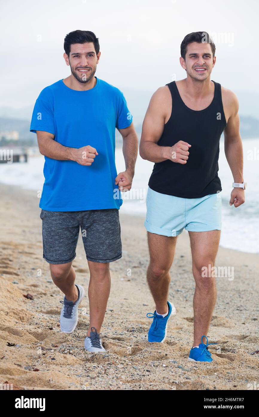 Adult men are jogging together Stock Photo - Alamy