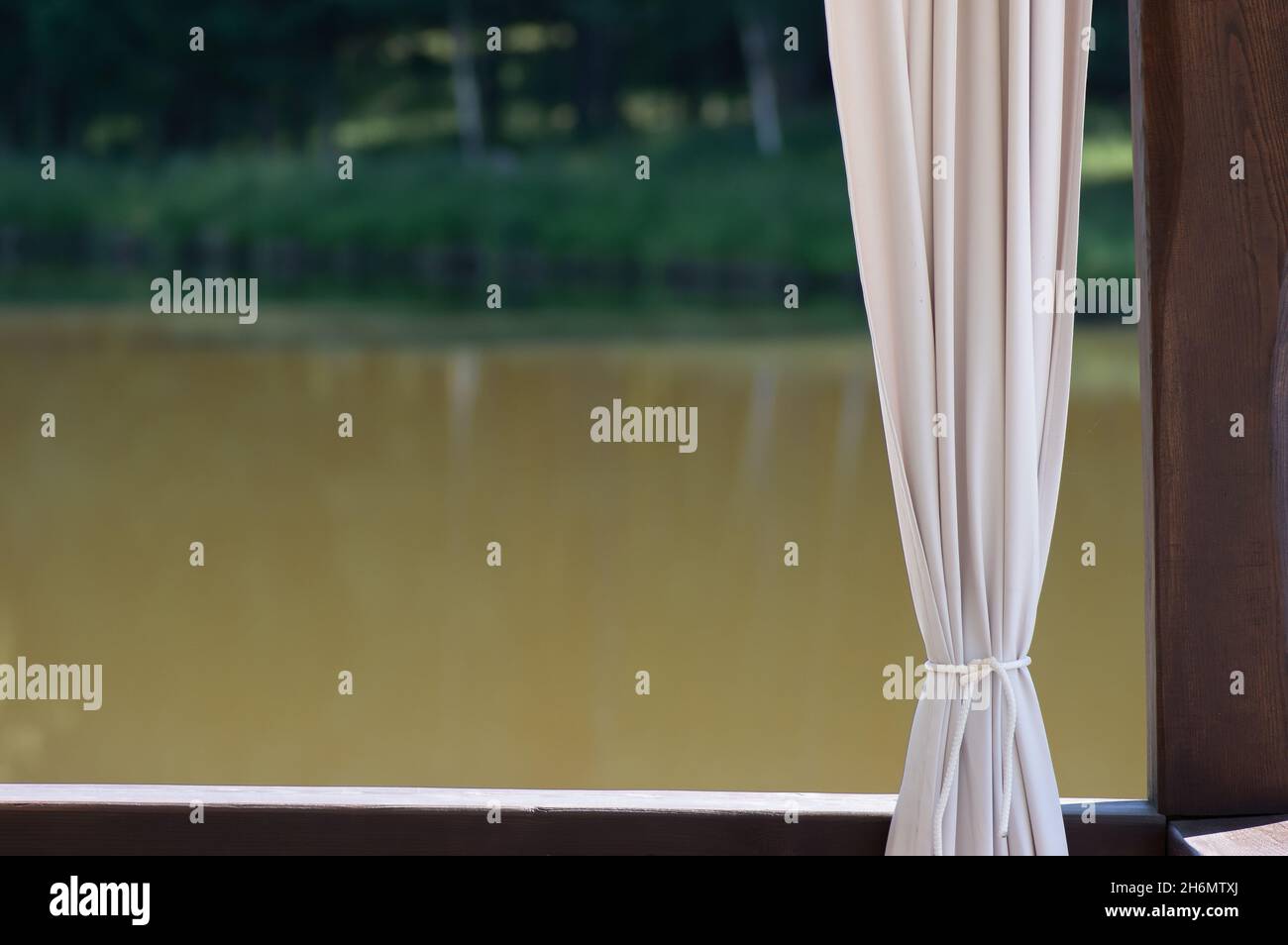 Window frame detail curtain by the countryside, water pond, rural ...