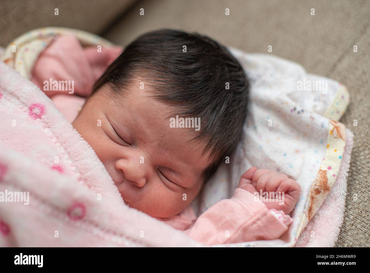 Cute Hispanic baby girl sleeping on a white and pink blanket Stock ...