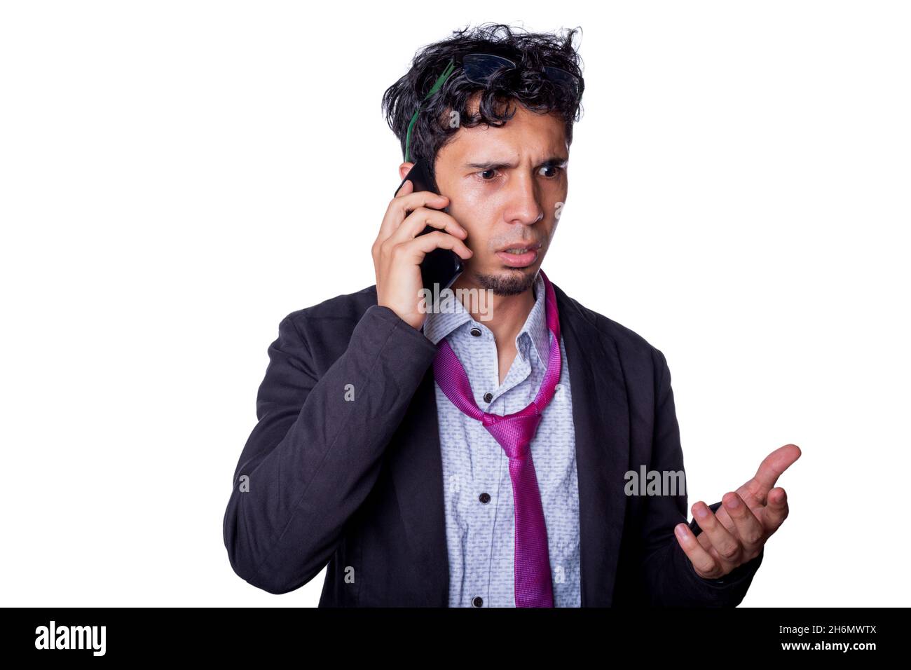 Businessman talking on the phone in surprise. Very unkempt young latin ...