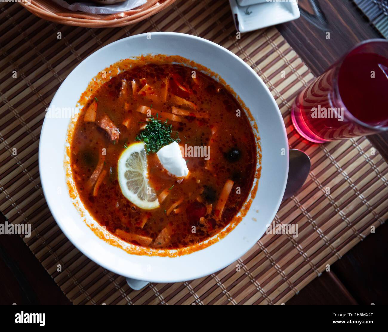 Traditional Russian meat soup Solyanka with sour cream and lemon Stock ...