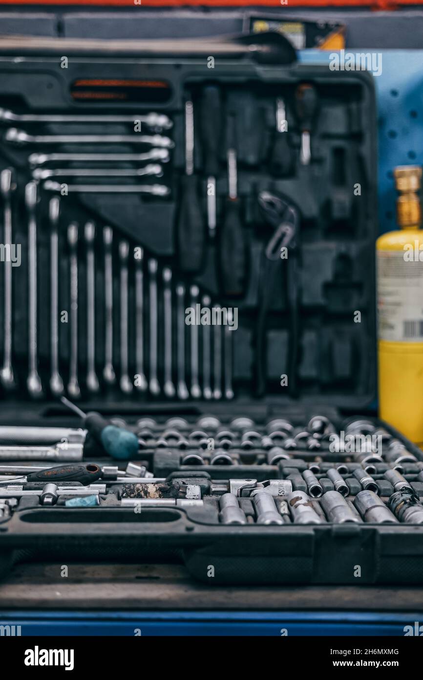 An open toolbox lies on the floor in the garage. Side view Stock Photo ...
