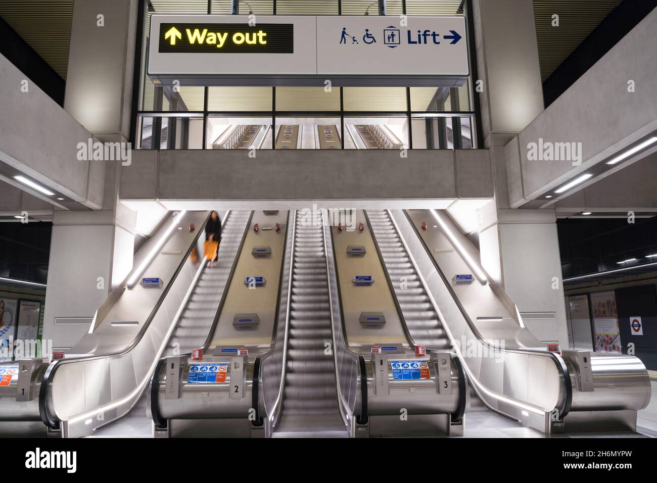 man stand on an Escalator leading from ticket hall to the station ...