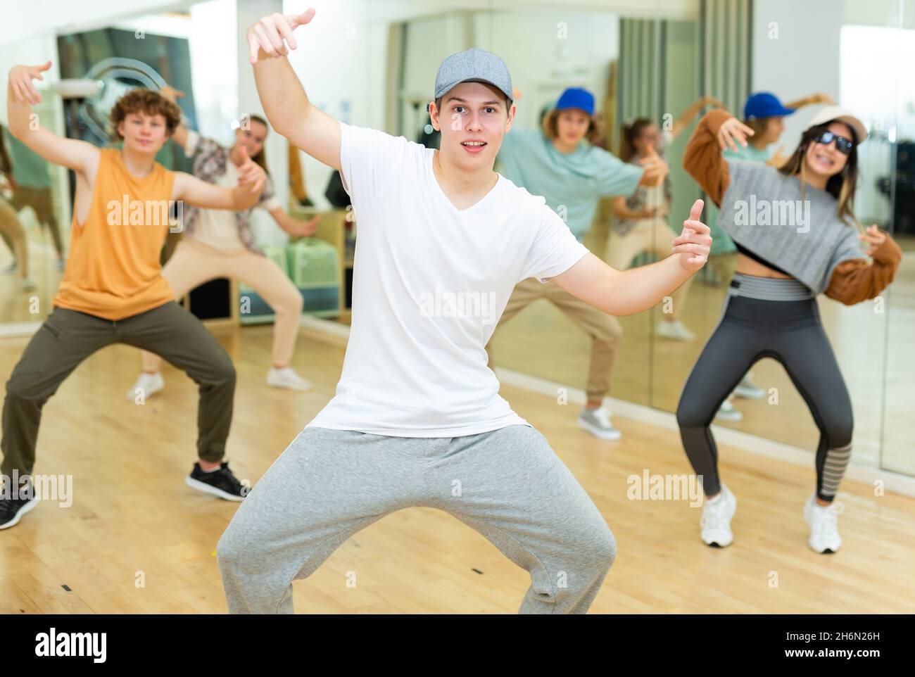 Teenage krump dancer dancing with teenagers in choreographic studio ...