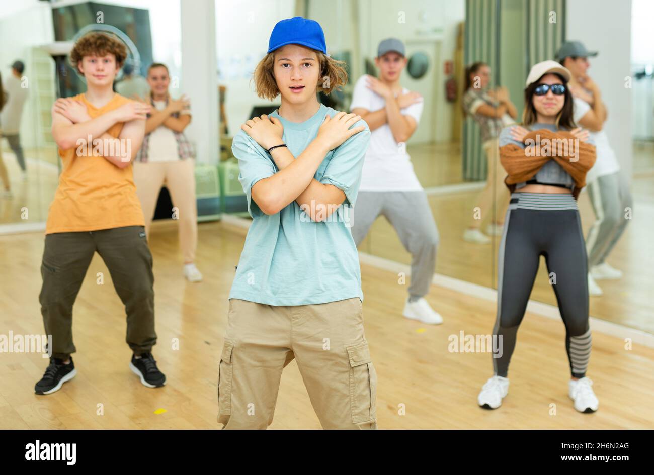 Teenage boy practicing hip-hop movements with group in studio Stock ...