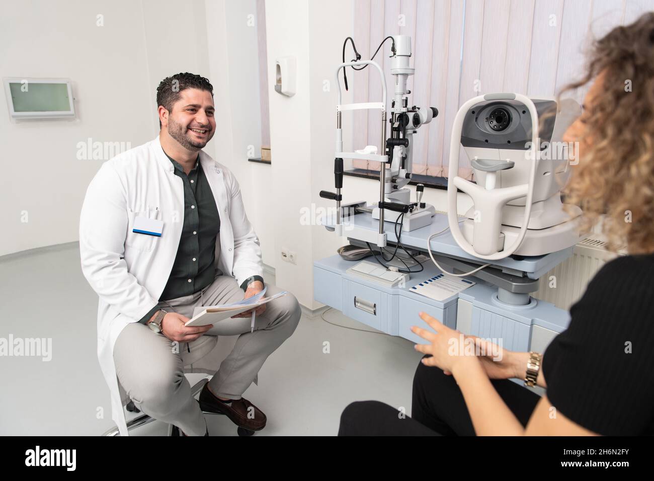 Male Eye Doctor Listen Carefully Young Woman in Office Portrait Stock ...