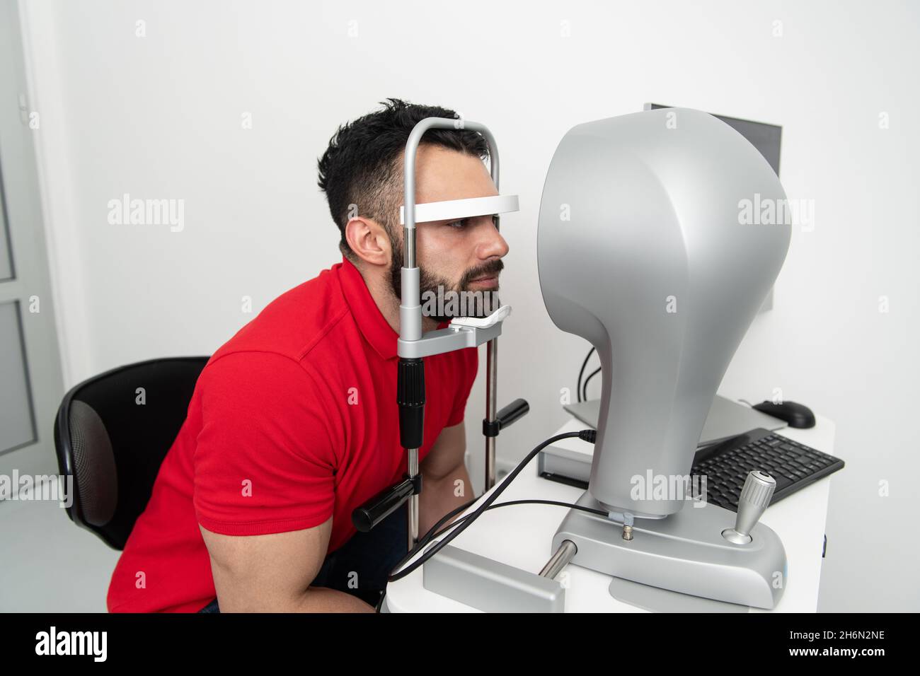 Young Man Is Checking the Eye Vision in Modern Ophthalmology Clinic ...